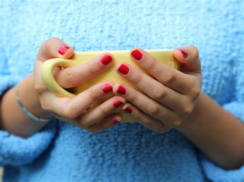 Premium Photo Midsection Of Woman With Red Nail Polish Holding Yellow Cup
