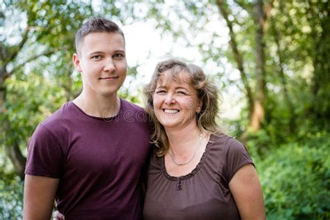 Smiling Mother Posing With Adult Son Outdoors Stock Image Image Of