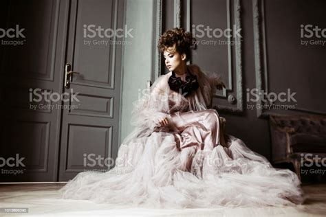 Fashionable Female Portrait Of Cute Lady In Pink Dress Indoors Stock