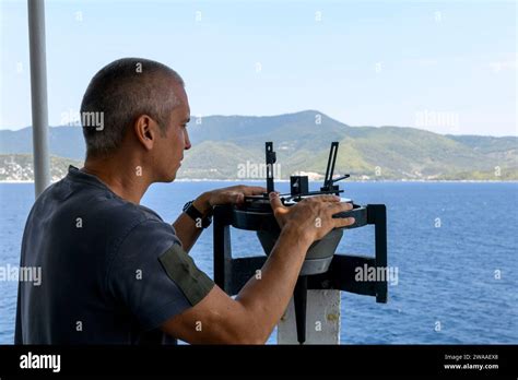 Navigational Officer Taking Bearing With Azimuth Ring On Gyro Compass