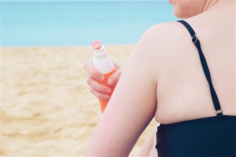 Premium Photo Woman On The Beach Puts Sunscreen Cream On Hands From