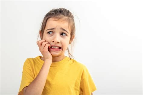 Premium Photo Scared And Anxious Girl Biting Her Fingernails On A