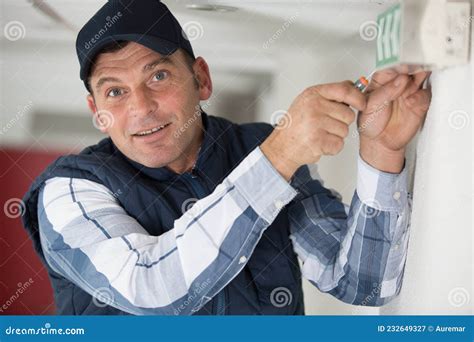 Man Fixing Exit Sign To Wall Stock Image Image Of Accident Male
