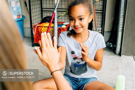 Sisters Playing Hand Clapping Game Superstock