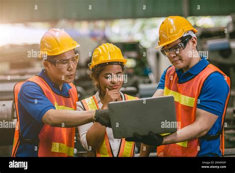 Engineer Team Mix Race Man And Woman Working Together In Heavy Industry With Laptop Computer