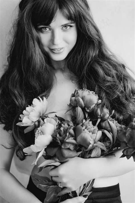 A Beautiful Woman Topless With Long Hair And A Bouquet Of Peonies
