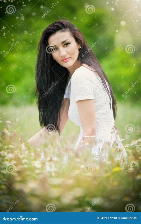 Beautiful Young Woman In Wild Flowers Field Portrait Of Attractive