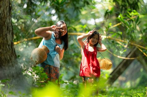 Two Girls Asian Women With Traditional Clothing Stand In The Rainforest