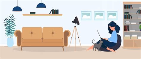 La Fille Est Assise Sur Un Pouf Et Travaille Sur Un Ordinateur Portable