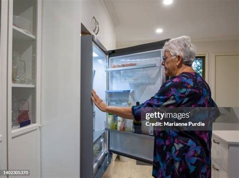 Woman Looking Into Refrigerator Photos And Premium High Res Pictures