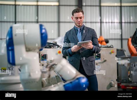 A Professional In Business Attire Checks A Tablet While Monitoring