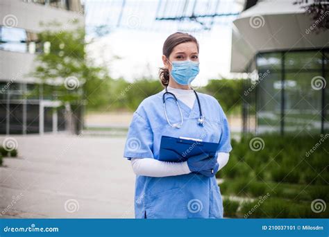 Young Female Ems Key Worker Doctor In Front Of Healthcare Icu Facility
