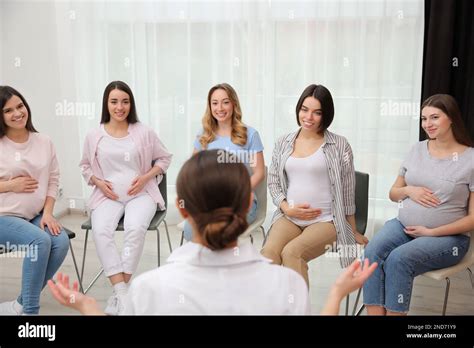 Group Of Pregnant Women With Doctor At Courses For Expectant Mothers