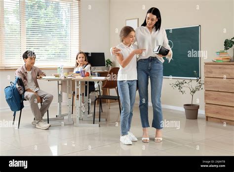 Female Teacher Showing Vr Glasses To Pupil In Classroom Stock Photo Alamy