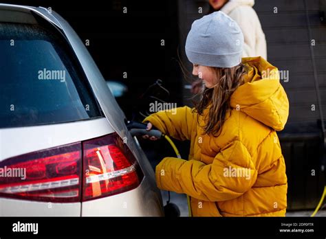 Girl Charging Electric Car Stock Photo Alamy