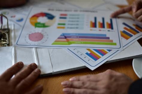 Premium Photo Cropped Colleagues Analyzing Charts On Office Desk