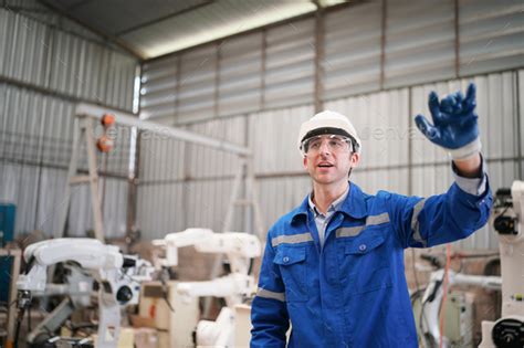 robotics engineer operating robot aided cnc machine in robotics