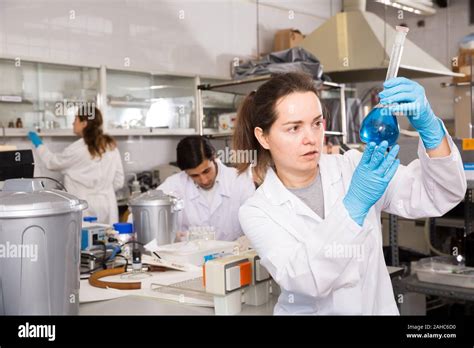 Focused Woman Lab Technician Working With Reagents In Test Tubes During Chemical Experiment