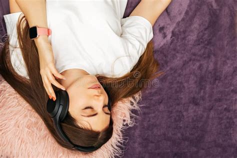 Woman Wearing Earphones While Lying In Bed Stock Photo Image Of