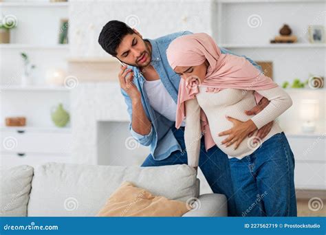 Pregnant Muslim Woman Having Prenatal Contractions Caring Husband
