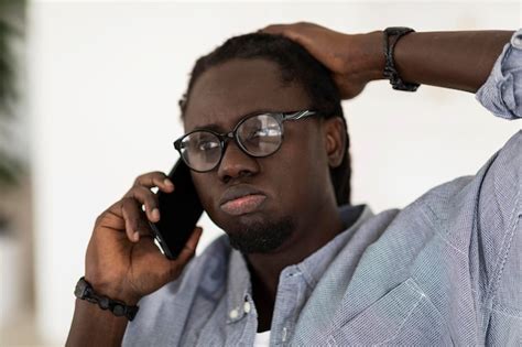 Premium Photo Stressed Black Male In Eyeglasses Touching Head While