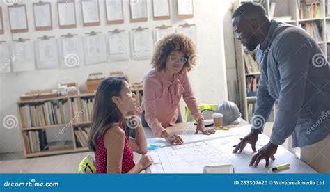 Busy Diverse Architects Discussing Blueprints On Table In Office Slow Motion Stock Footage