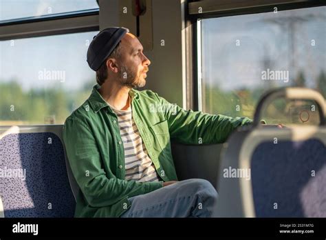 Tourist Immersed In Thoughts Looking Through Window Traveling By Train