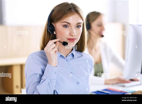 Portrait Of Call Center Operator At Work Group Of People In A Headset