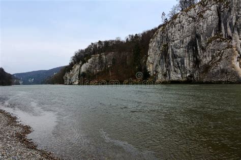 Rocks With Trees Above A Picturesque River A Wide Stream Flows Into