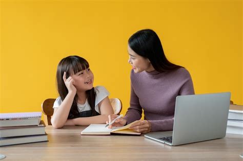 Premium Photo A Kind Asian Female Teacher Is Teaching Math To A Cute