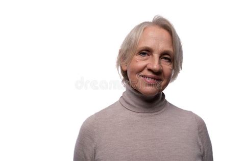 A 65 Year Old Pensioner Woman With A Short Haircut Looks Friendly At