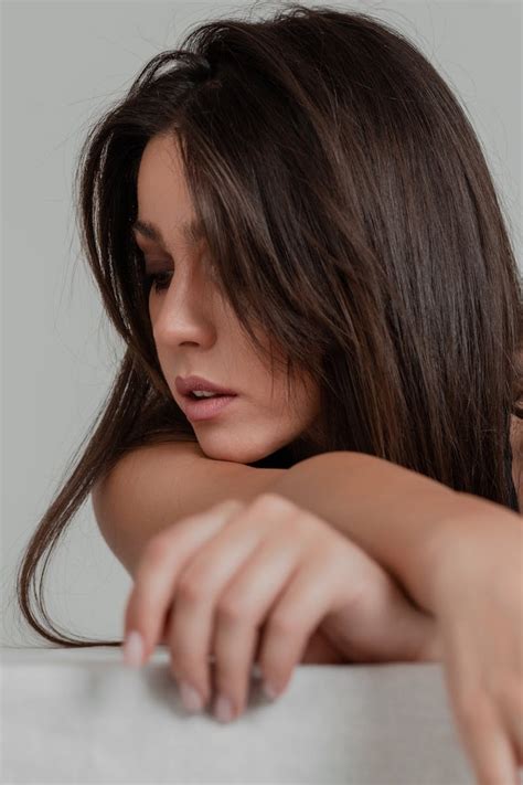 Closeup Of A Girl With Black Wet Hair Lying On A Stone In A River
