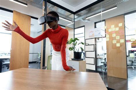 Woman Using Vr Headset In Modern Office Interacting With Virtual