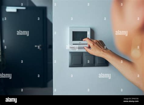 woman controlling office with digital touch screen panel installed on