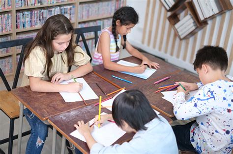 Elementary School Students Work Together On Assignments Brainstorm And Collect Ideas And Write