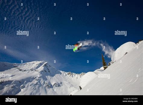 A Snowboarder Catching Some Air At Rogers Pass Glacier National Park