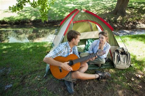 Premium Photo Cute Man Serenading His Girlfriend On Camping Trip