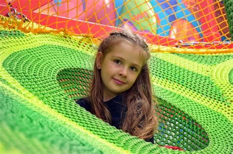 Premium Photo Portrait Of Girl Playing In Jungle Gym