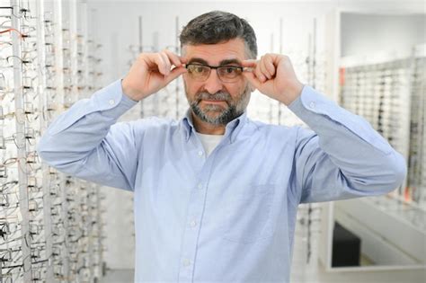 Premium Photo Male Customer Choosing Glasses In Optics Store