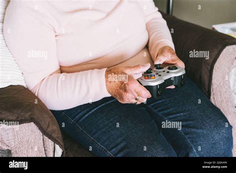 Close Up Senior Mature Woman Hands Using Wireless Controller Joystick Gamepad Playing Video