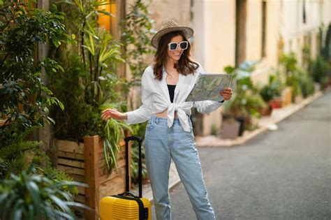 Premium Photo Cheerful Millennial European Woman Tourist In Hat And