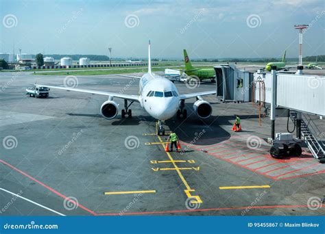 Loading A Passenger Plane On The Airport Tarmac With The Passengers
