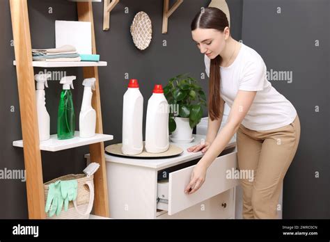 Beautiful Woman Opening Drawer In Laundry Room Stock Photo Alamy