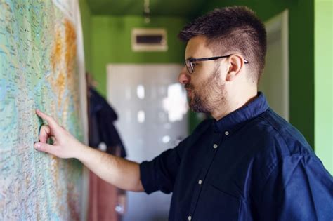 Premium Photo Man Pointing At Map On Wall