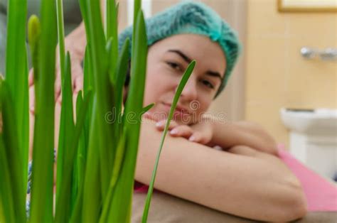 Side View Of Satisfied Smiling Female Patient Receiving Back Massage