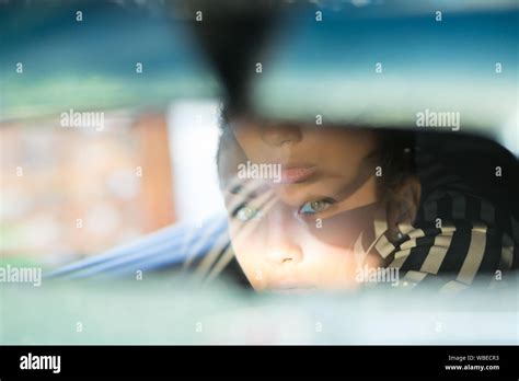 Beautiful Woman Driver Reflecting In The Rear View Mirror Driving Her Car Concept Artistic