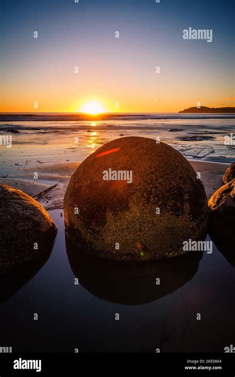 A Vertical Of Moeraki Boulders Beach In Hampden New Zealand At Sunset