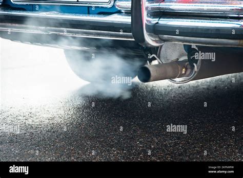 combustion fumes coming out of car exhaust pipe, exhaust gas from a car with diesel or gasoline ...