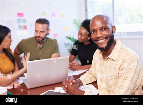 Portrait Of Smiling Black Man Development Team Mobile App Coding