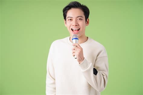 Premium Photo Image Of Young Asian Man Holding Microphone On Background